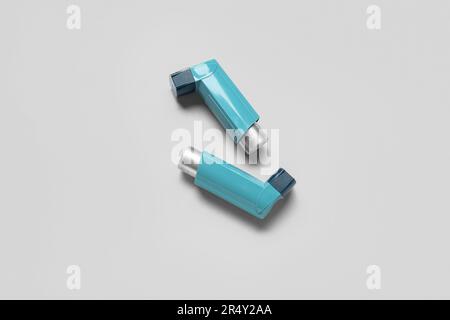 Asthma inhalers on grey background Stock Photo - Alamy