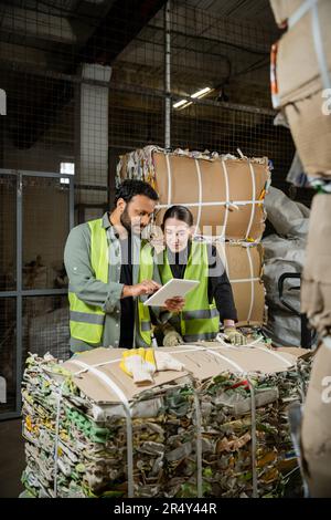 Caucasian Modern Garbage Truck Worker Riding on a Rear Side of the ...