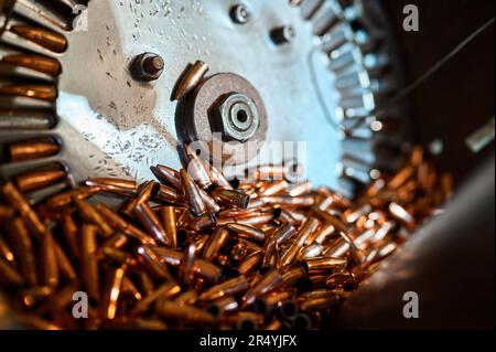 Pile of Copper bullet shells and turning wheel at production line Stock ...