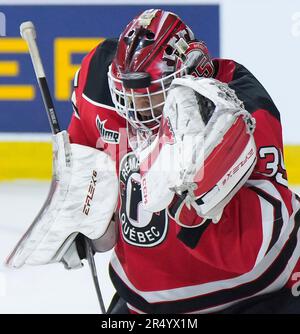Quebec Remparts goalie William Rousseau, second right, stops Seattle ...
