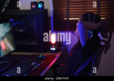 Female cyber hacker gamer watching monitor and making win gesture after ...