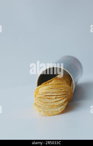 potato chips spilling form a packet on table Stock Photo - Alamy