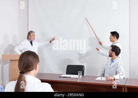 Doctors giving lecture near projection screen in conference room Stock ...
