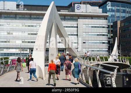 View of pedestrians crossing Tradeston Bridge or Squiggly bridge at ...