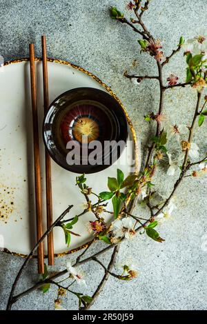 Spring table setting with chopsticks decorated with blooming cherry ...