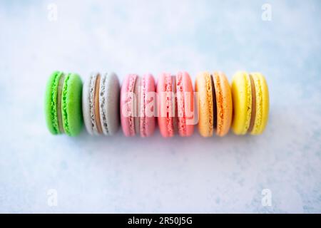 Rainbow colored macaroons in a row isolated on white background Stock ...
