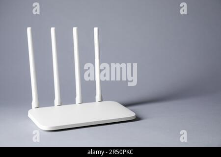 New stylish Wi-Fi router on grey background Stock Photo - Alamy