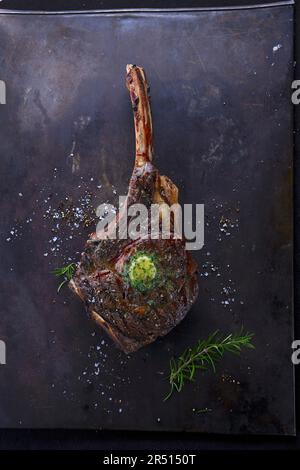 Grilled tomahawk steak with herb butter Stock Photo - Alamy