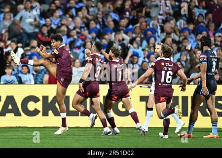 Selwyn Cobbo of the Maroons celebrates his try with Reece Walsh and ...