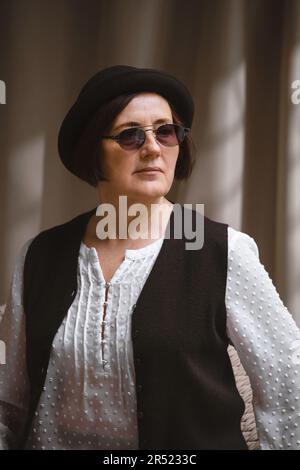 Brunette woman with hat and light beige dress on Ibiza pier Stock Photo ...