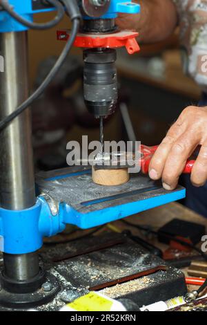 Detail of hands working on drilling machine Stock Photo - Alamy