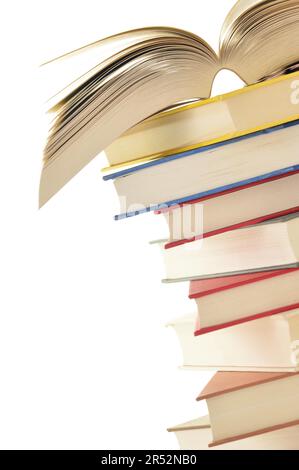 stack of colored books on white desk closeup Stock Photo - Alamy