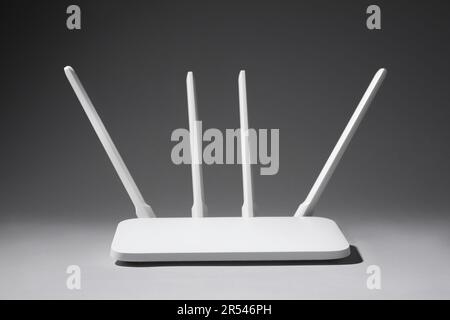 New stylish Wi-Fi router on grey background. Space for text Stock Photo ...