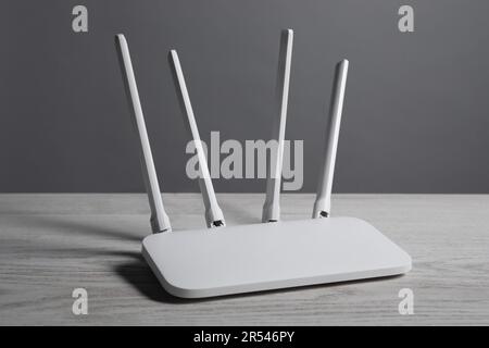 New stylish Wi-Fi router on grey background Stock Photo - Alamy