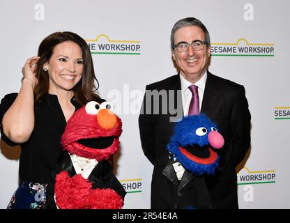 CNN anchor Erica Hill, left, and John Oliver pose with Count von Count, Elmo and Grover at the ...