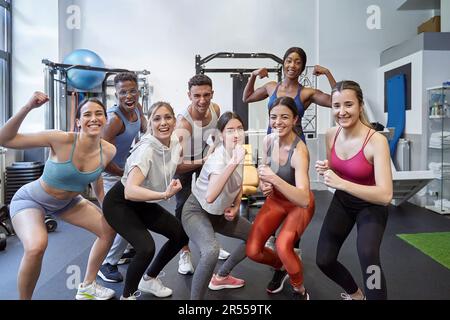 Diverse Group of Friends at the Gym, Positively Engaged, Flexing ...