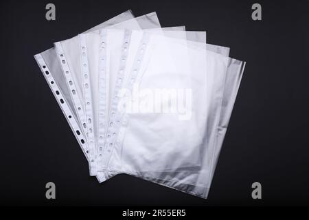 Punched pockets on black background, flat lay Stock Photo - Alamy