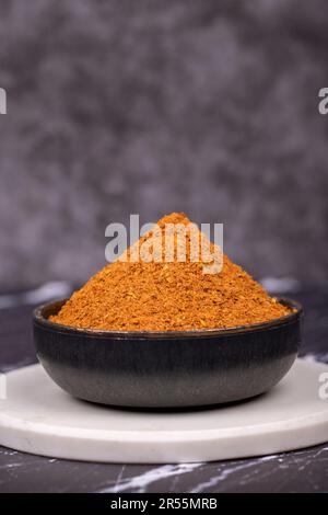 Cajun spice powder on dark background. Powdered dried cajun in bowl ...