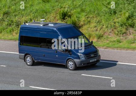 2011 blue Ford Transit 115 T330M FWD window van; Vehicular traffic ...