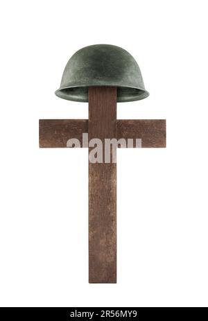 Wooden cross on grave of fallen soldier and workers levelling field on ...