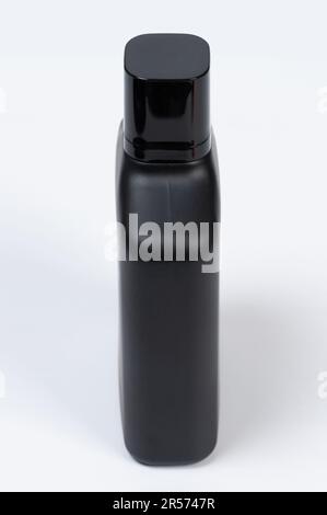 Black perfume spray bottle side view isolated on studio background ...