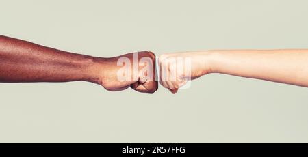 Closeup of multicultural friends giving fist bump to each other. Black ...