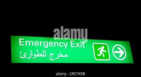 Emergency exit sign in an international airport in Middle East with ...