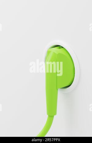 Green plug in a wall socket, green energy concept, energy transition ...