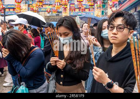 Young Chinese People Worshipping At The Wong Tai Sin Temple, Hong Kong ...