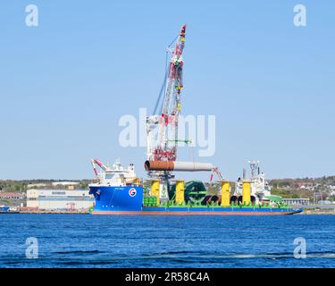 the Orion Offshore Heavy Lift crane moving wind turbine monopiles from ...