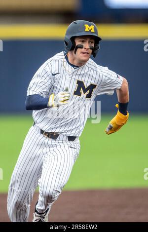 Michigan Wolverines second baseman Ted Burton (3) follows through on ...
