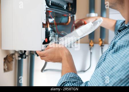 worker opening a boiler at home Stock Photo - Alamy
