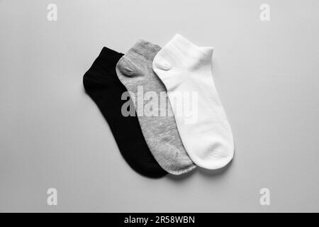 Different socks on light grey background, flat lay Stock Photo - Alamy