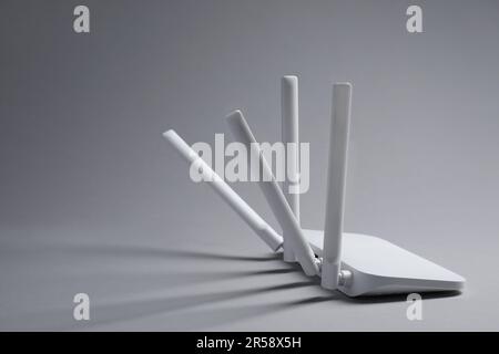 New stylish Wi-Fi router on grey background Stock Photo - Alamy