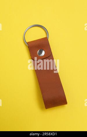 Leather keychain with Ukrainian coat of arms on pale pink background ...