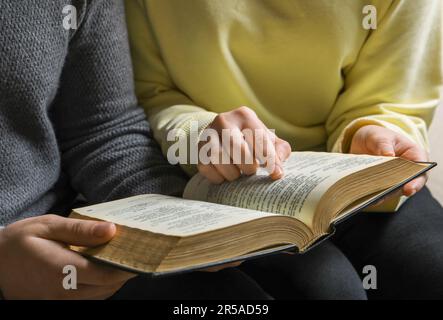 Couple sitting and reading holy Bible indoors, closeup Stock Photo - Alamy