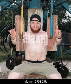 A man is seen exercising at the Kachalka outdoor scrapyard gym in Kyiv ...