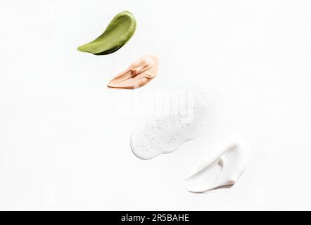 Cosmetic smears of green, pink and white colors cream on bright ...