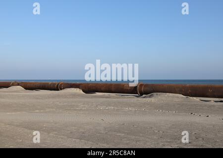 a steel pipe on the beach for conveying sand Stock Photo - Alamy