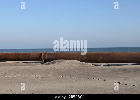 a steel pipe on the beach for conveying sand Stock Photo - Alamy