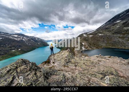 View of Lake Gjende and mountains, mountaineers on Besseggen hike ...