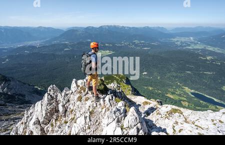 Mountaineers climbing the Obere Wettersteinspitze, behind Ferchensee ...