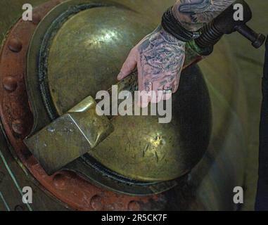 Distillery operator with tattoo working at Springbank distillery still ...