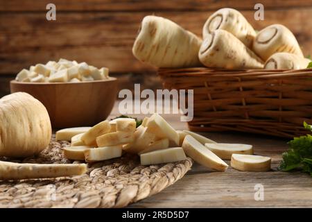Whole and cut parsnips on wooden table Stock Photo - Alamy