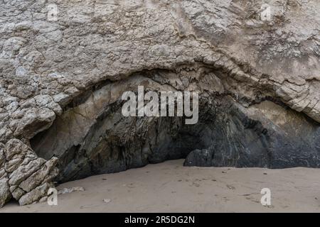 Natural oil seep at the bottom of the coastal cliff in Goleta, Southern ...