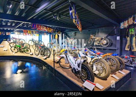 A selection of British Speedway bikes on a banked display and rider's ...