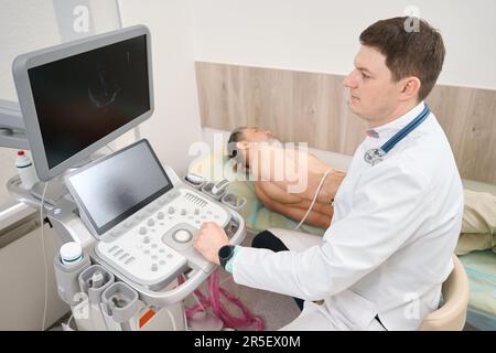Doctor making diagnostic examination of internal organs in children ...