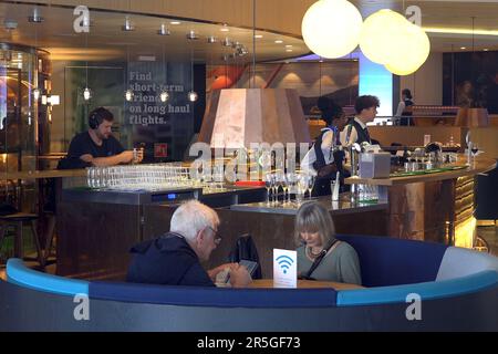 Passengers use WiFi access at the bar as they wait for their flight at ...