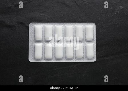 Black Blister with chewing gums on white background, top view with ...