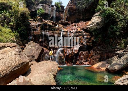 Tourist hiker looking at the spectacular Prut waterfall with turquoise ...